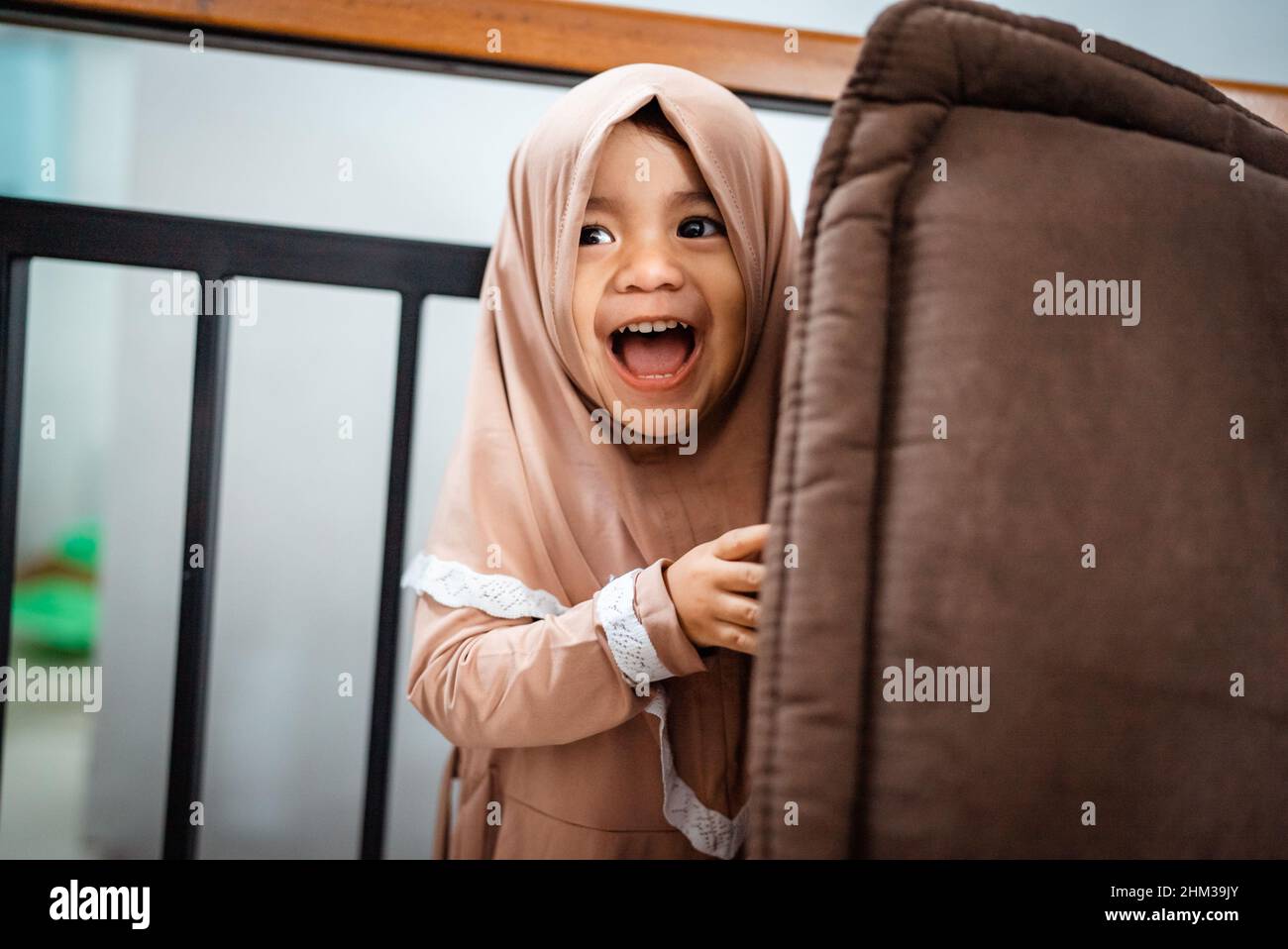 Cute Muslim toddler girl ini hijab at home Stock Photo - Alamy