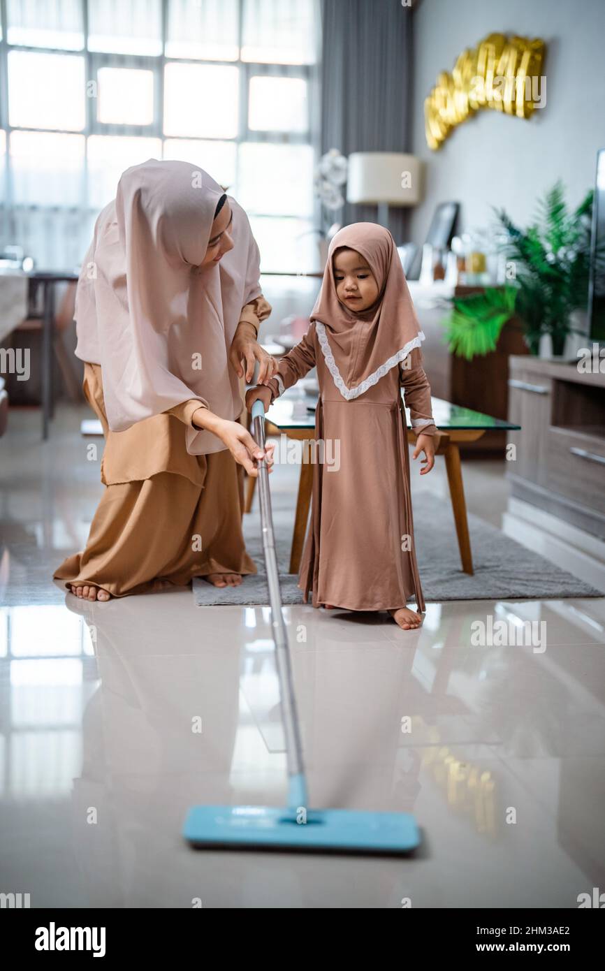 Happy muslim family cleans the room together Stock Photo - Alamy
