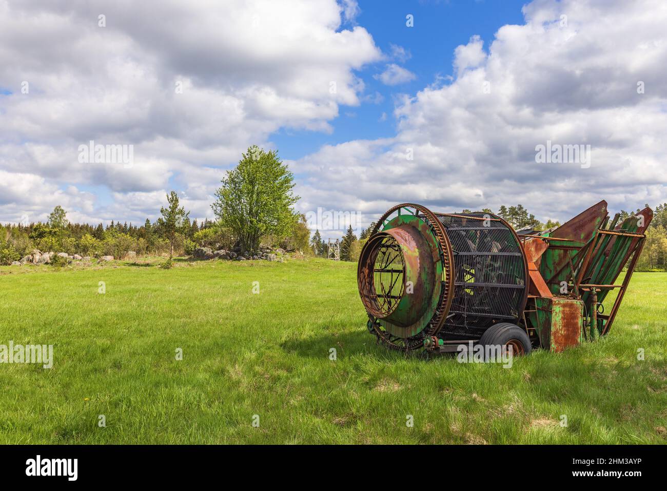 Old potato picker machine on a grass field Stock Photo - Alamy