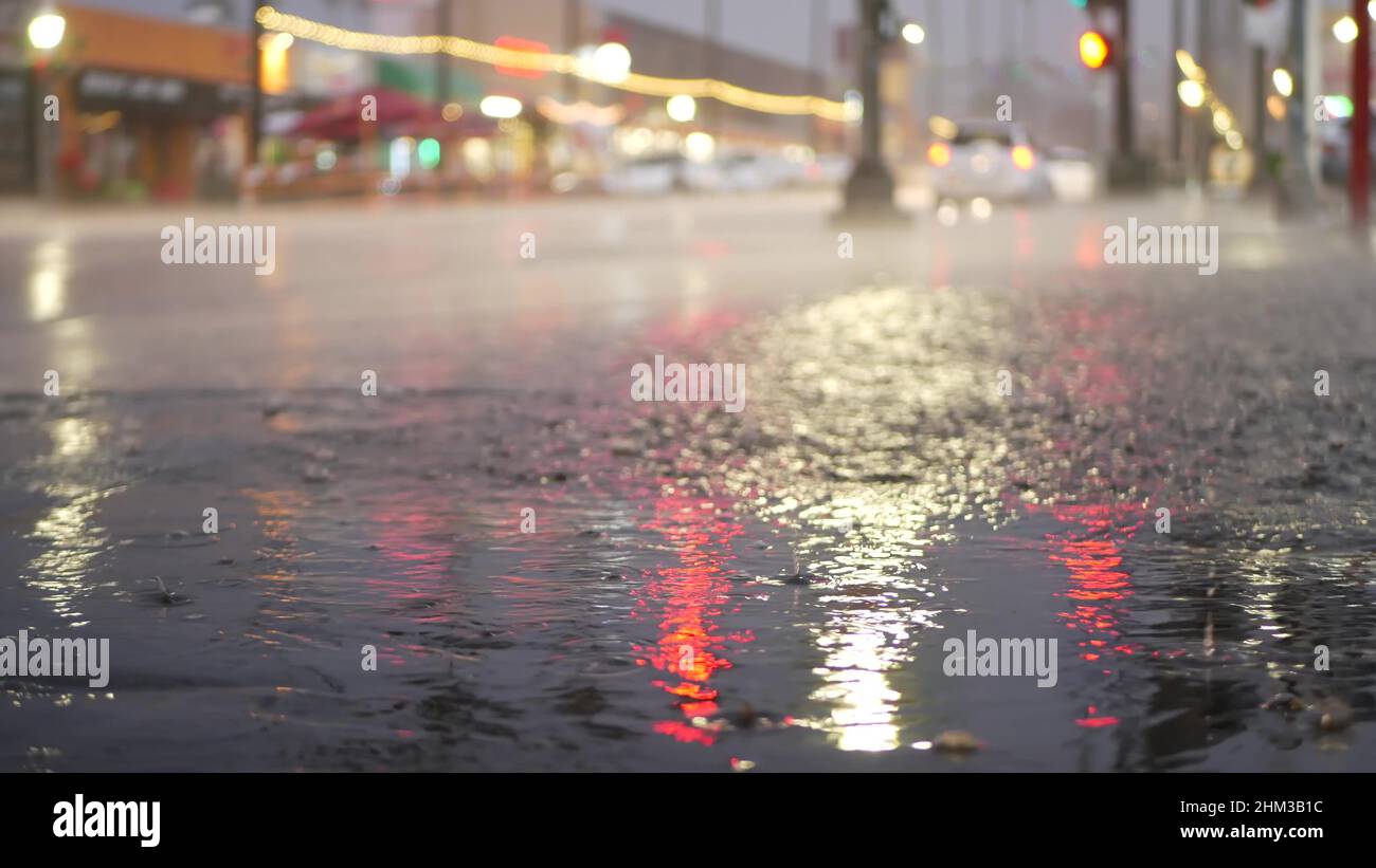 Cars lights reflection on road in rainy weather. Rain drops on wet ...