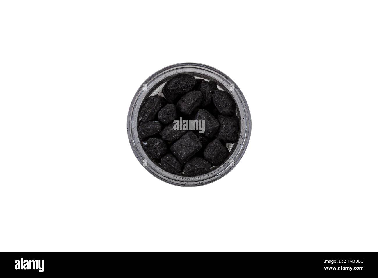 black incense in a round plastic box isolated on a white background top ...