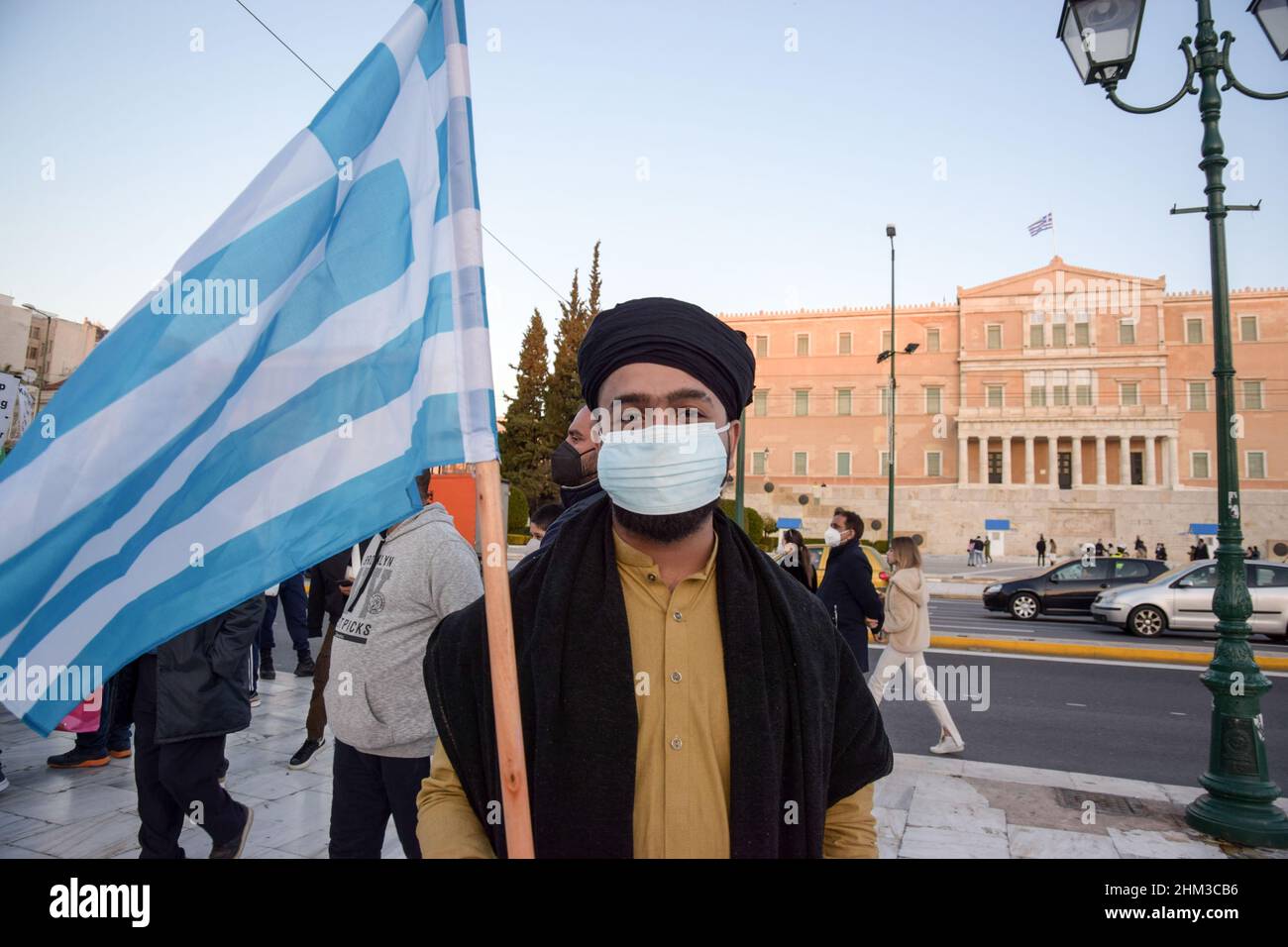A migrant from Pakistan seen holding a Greek flag ahead of the Greek ...
