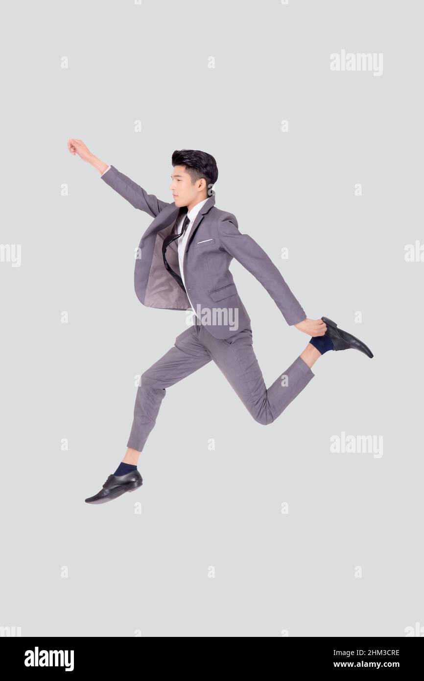 Young asian business man in suit jumping isolated on white background ...