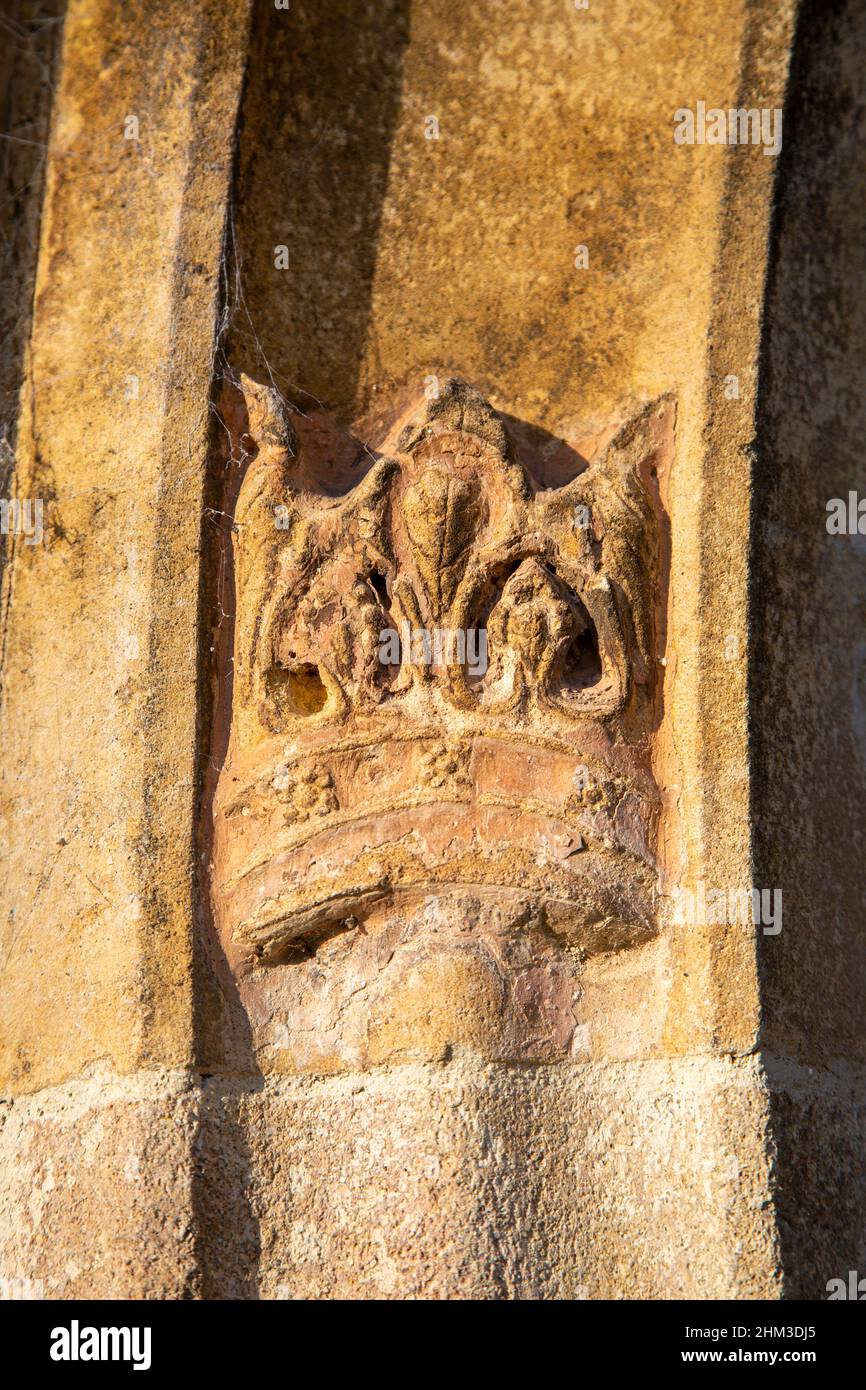 Weathered stonework carving of crown in porch of Syleham church ...