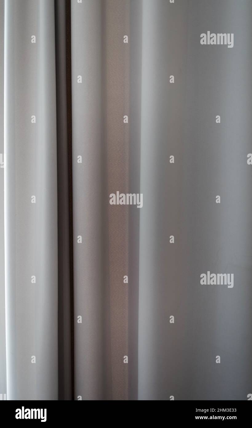 Light gray fabric curtain. front view. vertical image Stock Photo - Alamy