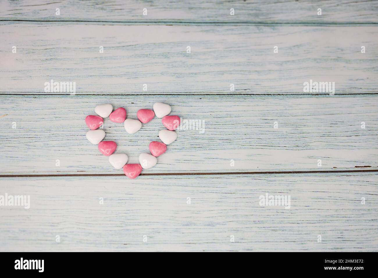 Colorful candy hearts on wooden background. Valentine's day Stock Photo ...