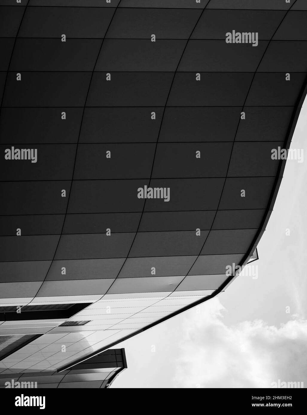 curved shape of a modern building. metal panels of the shopping center ...