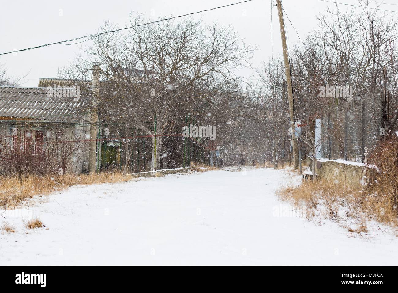 Falling snow in village, winter weather view in Georgia Stock Photo - Alamy