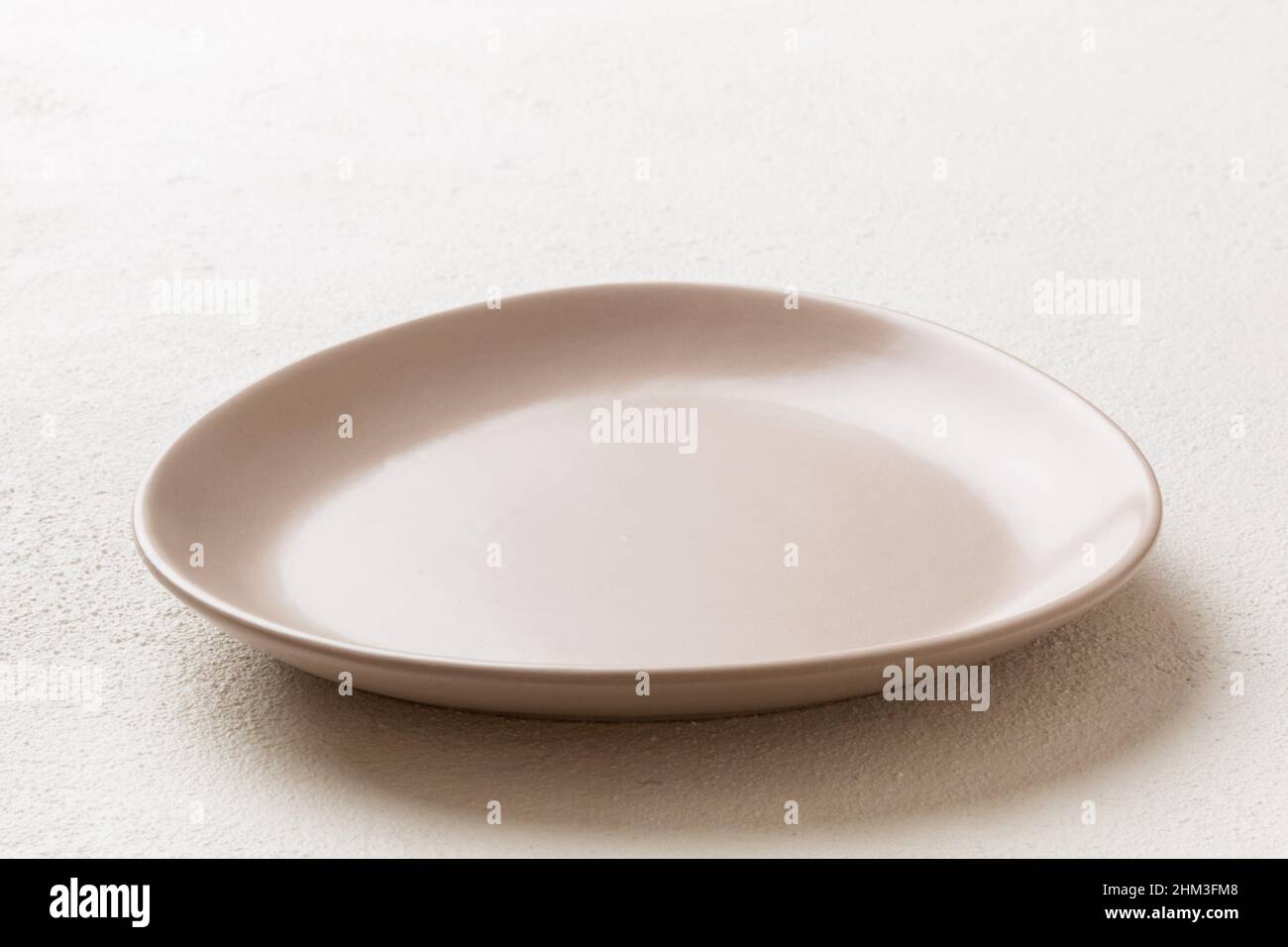 Perspective view of empty light plate on wooden background. Empty space ...