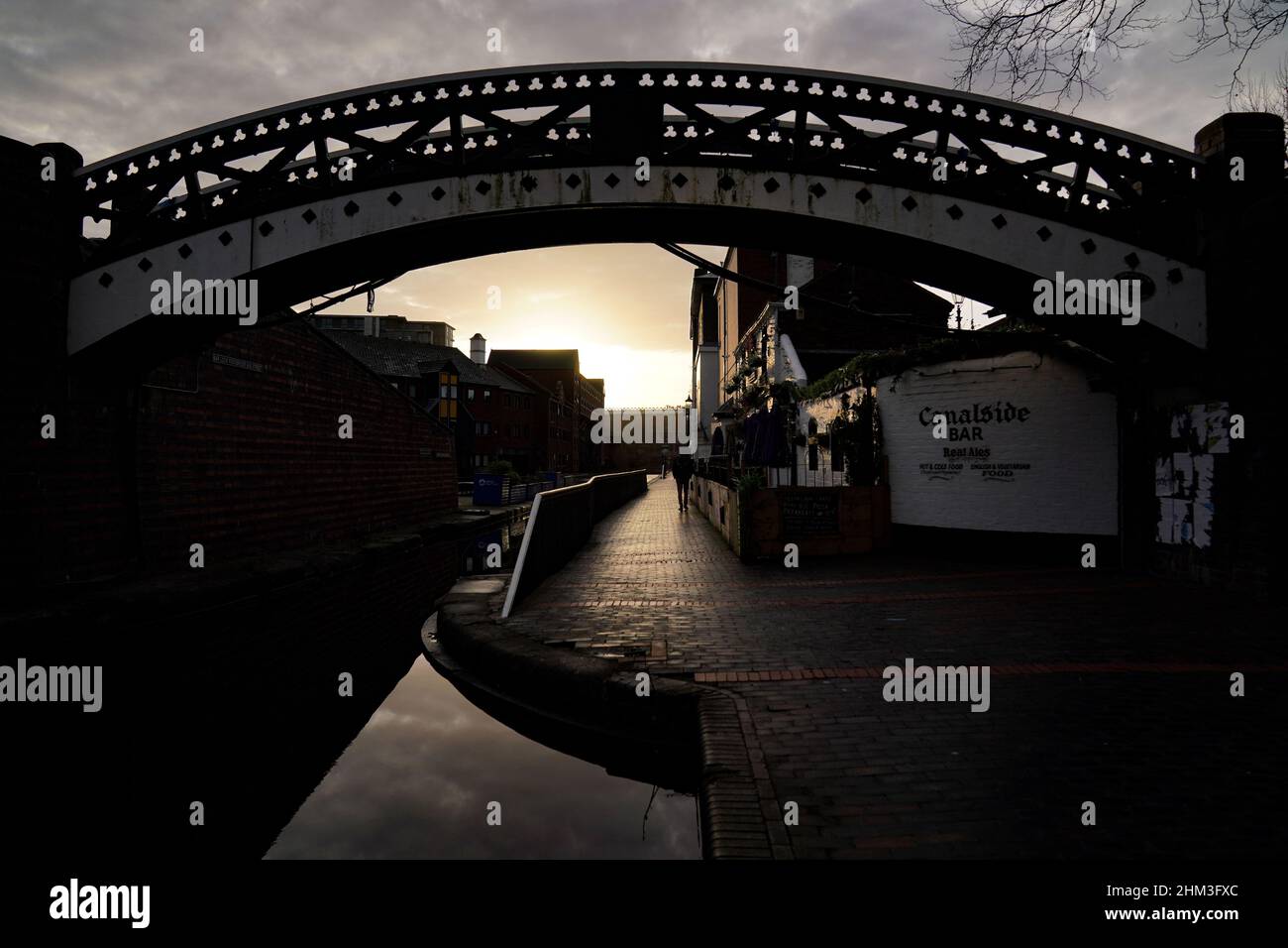 People walk by the Birmingham canal during sunrise. Picture date ...