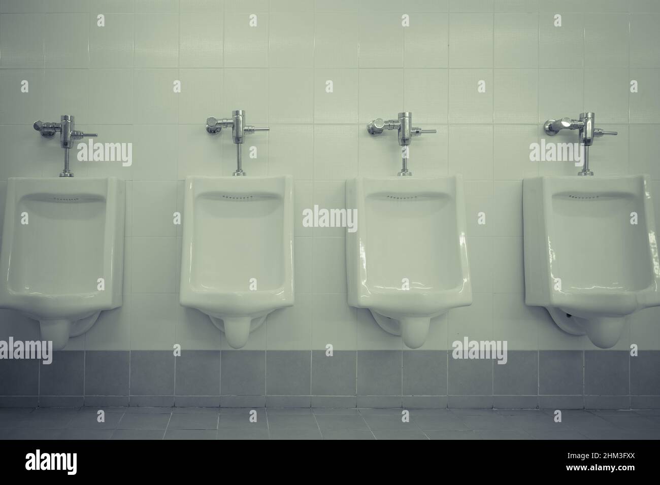Row of white urinals in men toilet room Stock Photo - Alamy