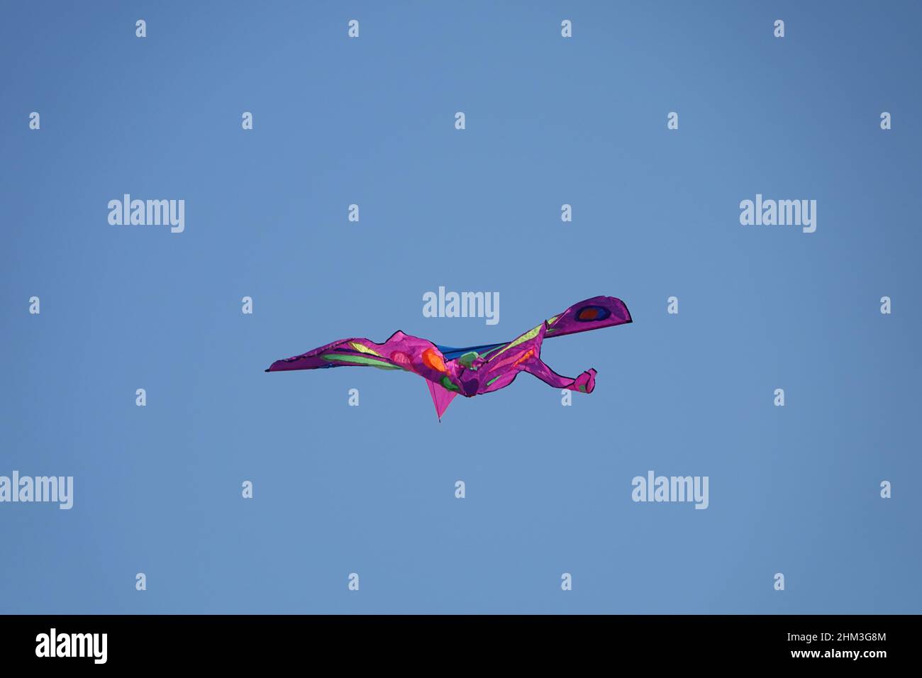 Colorful kite flying in the blue clear sky Stock Photo - Alamy