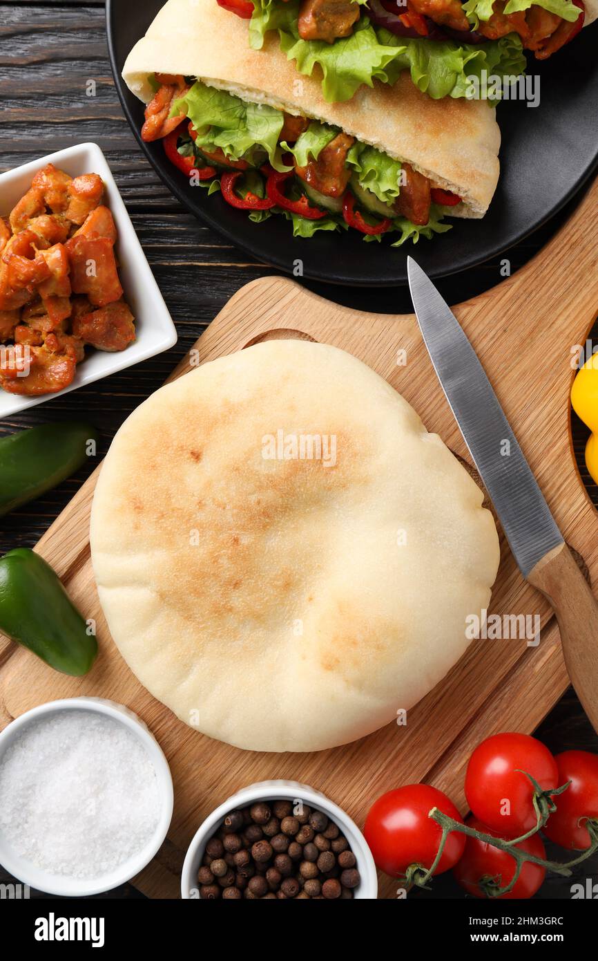 Concept of cooking pita with chicken on wooden background Stock Photo ...
