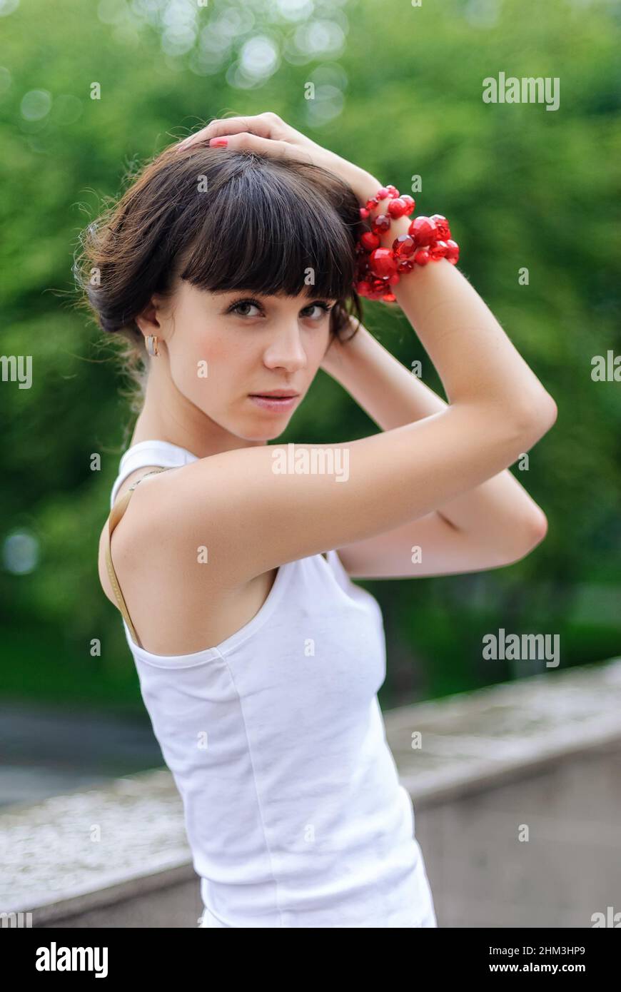 Attractive sad girl with red beads Stock Photo - Alamy