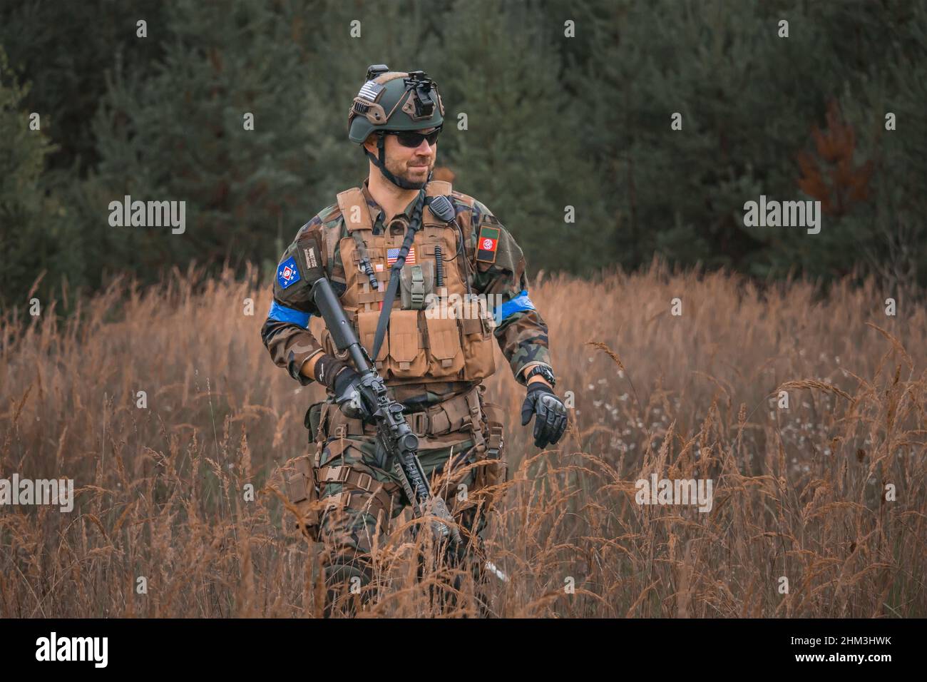 Real soldier in the forest with a special uniform Stock Photo - Alamy
