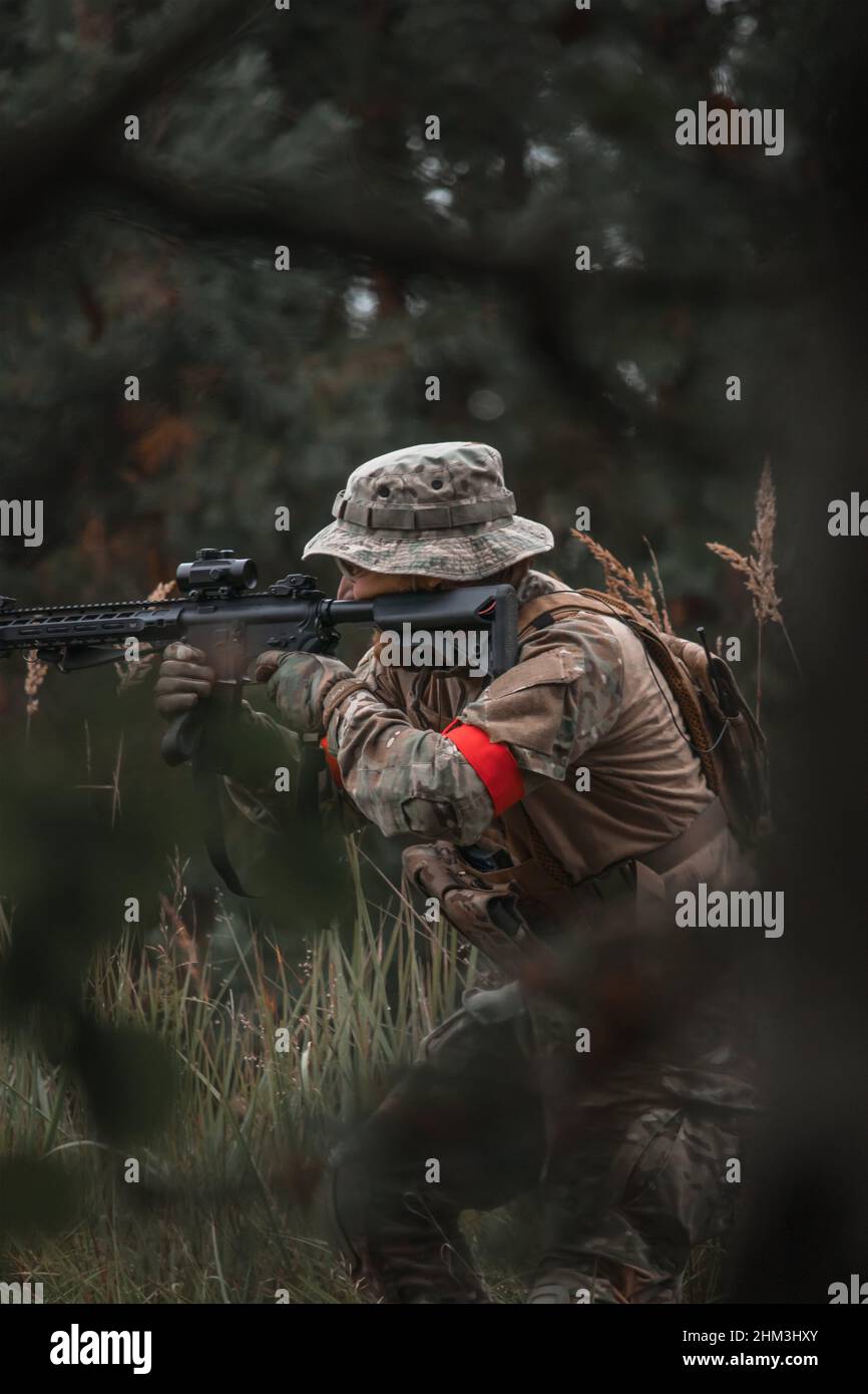 Real soldier in the forest with a special uniform Stock Photo - Alamy
