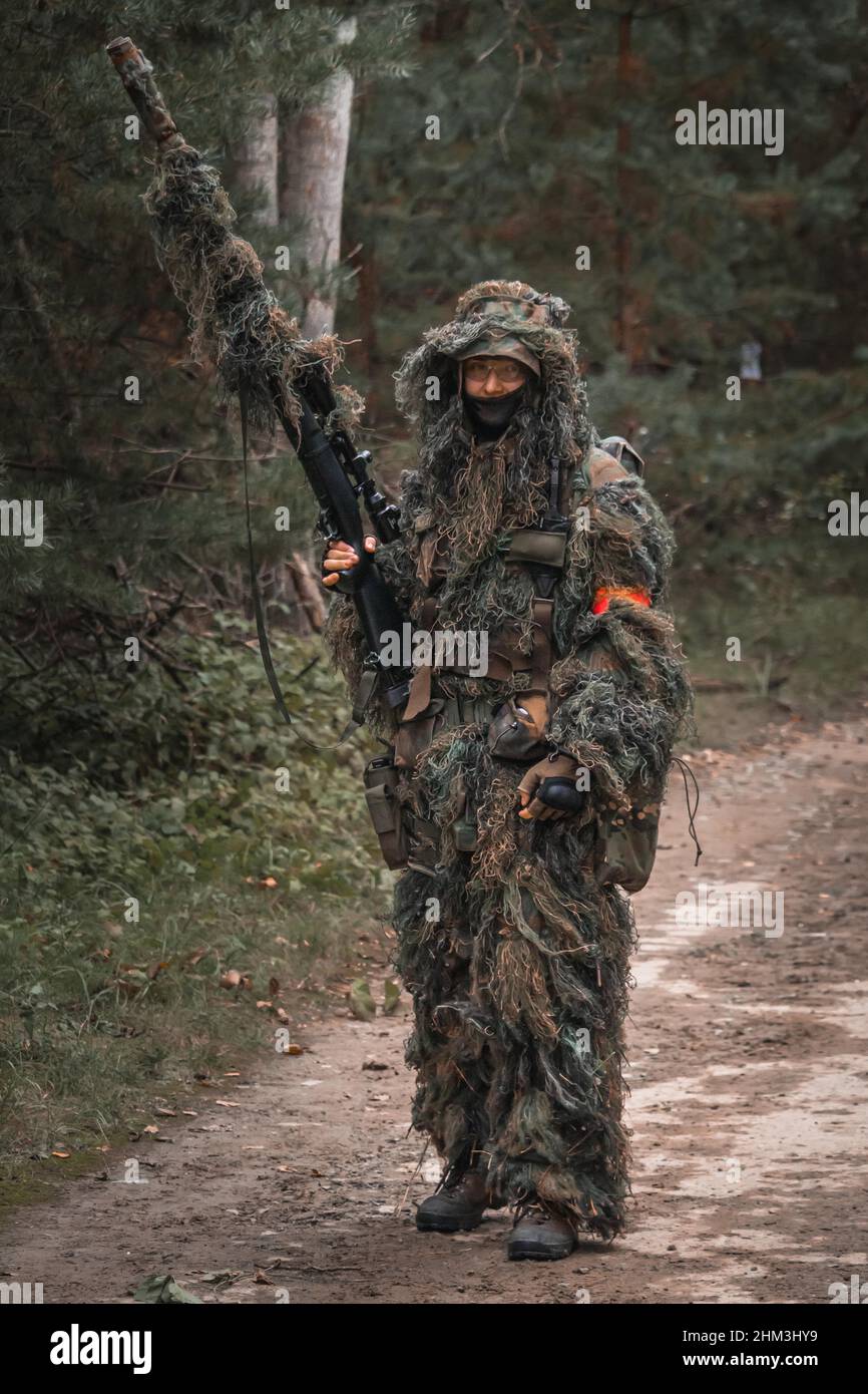 Real soldier in the forest with a special uniform Stock Photo - Alamy