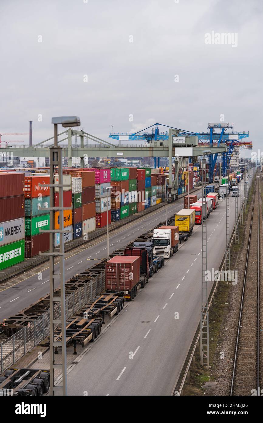 Vertical shot of cargo containers and trucks at container port on a ...