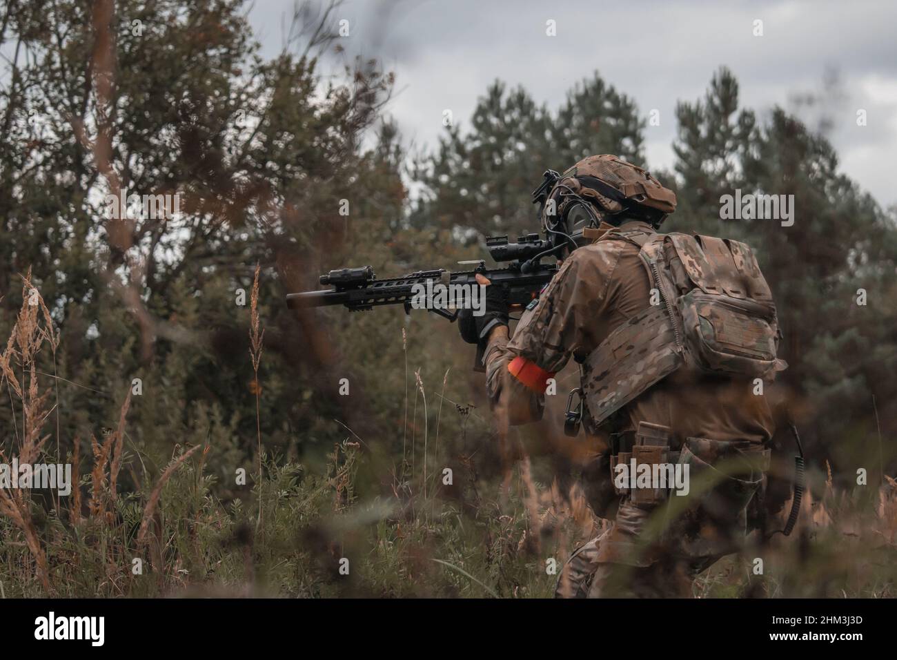 Real soldier in the forest with a special uniform Stock Photo - Alamy