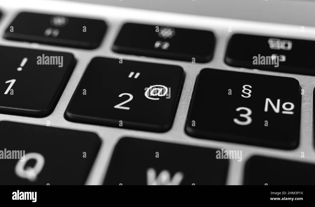 At sign key and button on keyboard close-up. Modern laptop ...