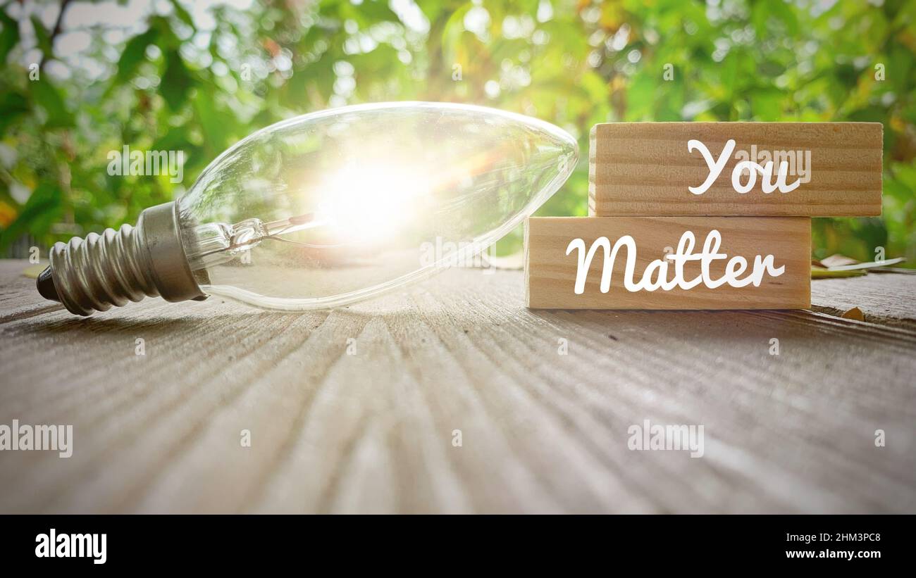 You matter text on wooden blocks with light bulb and nature background ...