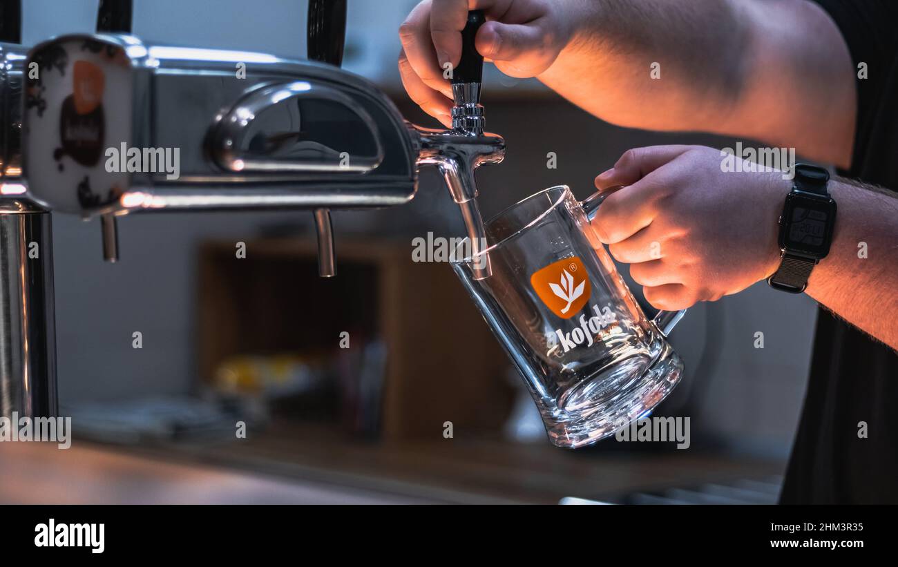 A man filling a cup with beer in a bar Stock Photo - Alamy
