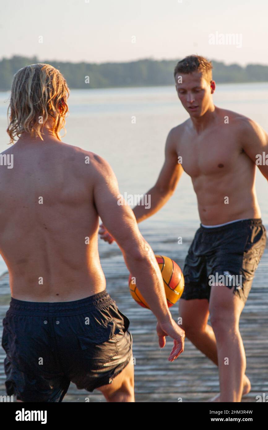 swimming and playing football a sumer night at sunset Stock Photo - Alamy