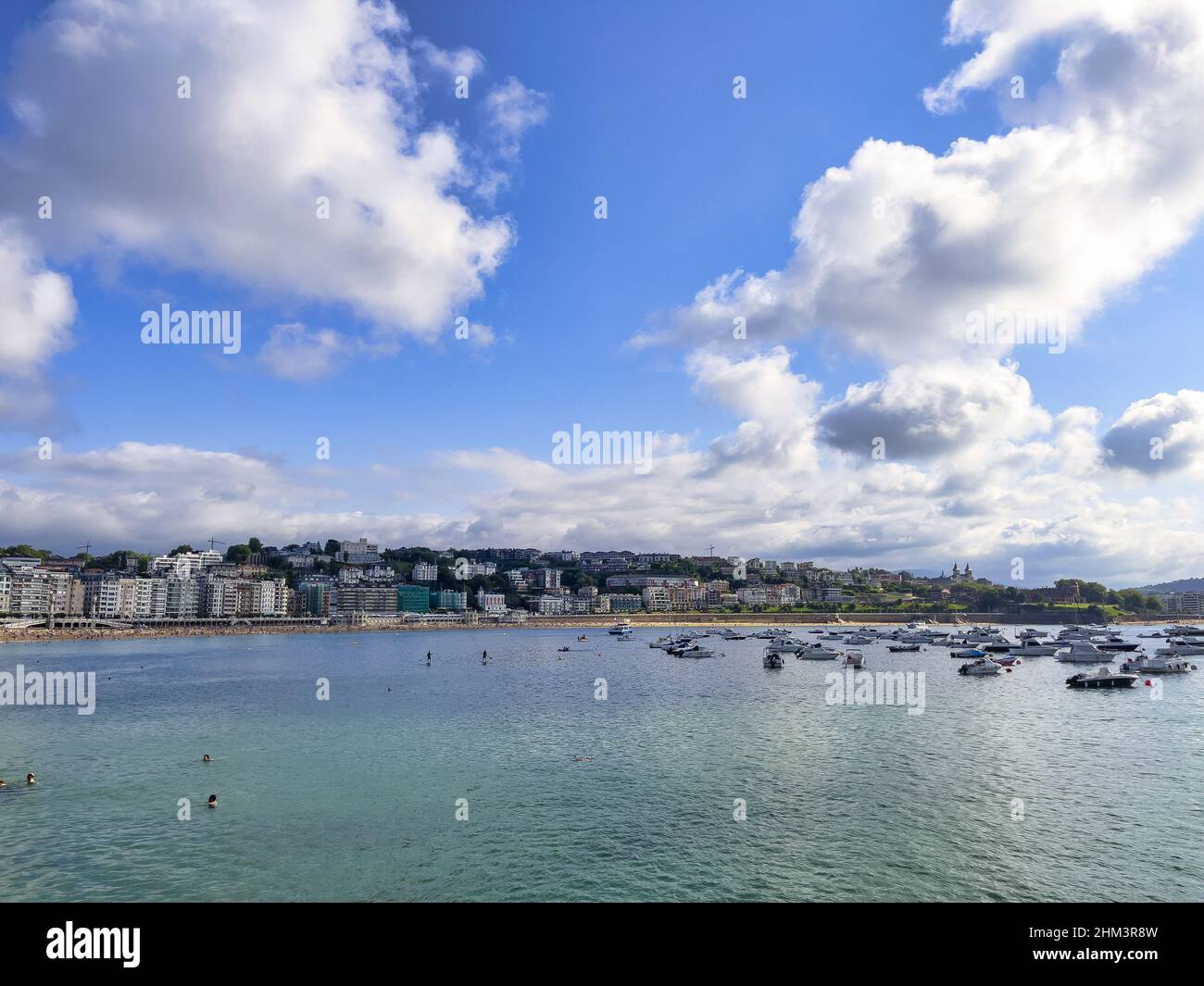 La Concha beach with boats and people Stock Photo - Alamy