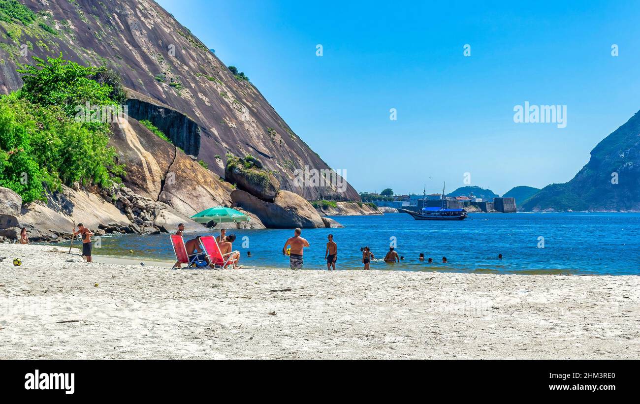 Mountain side in the Praia Eva. People enjoying the Summer outdoors ...