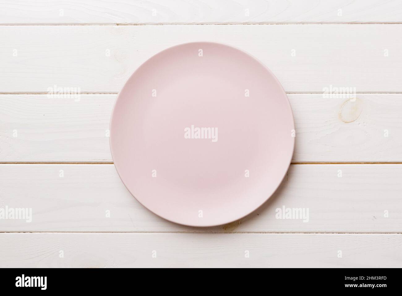 Top view of empty pink plate on wooden background. Empty space for your ...