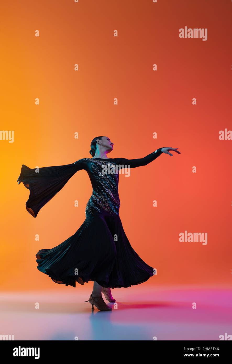 One young beautiful woman in stage dress dancing ballroom dance ...