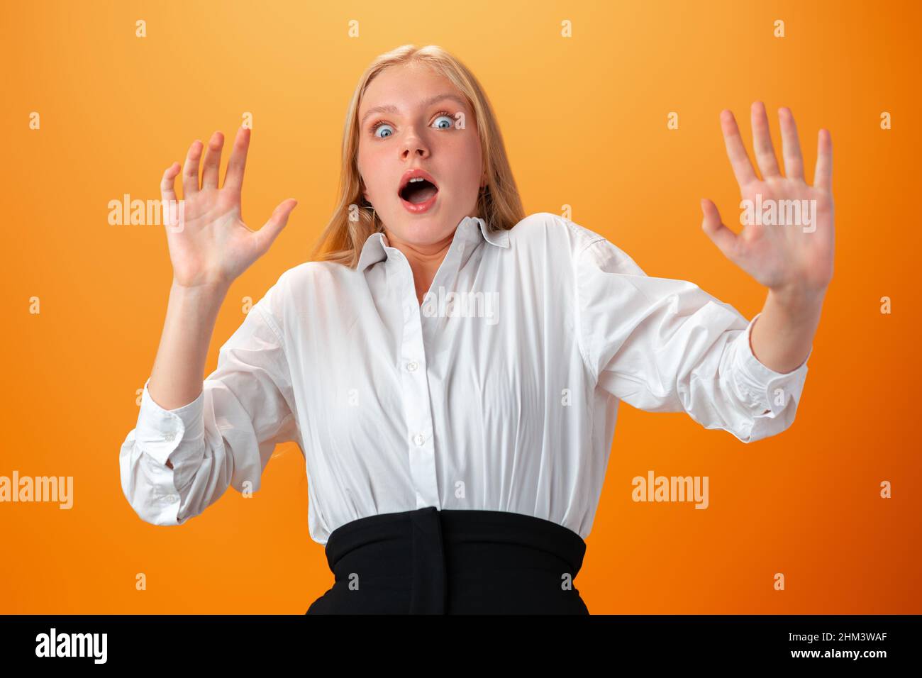 Photo of worried nervous teen girl afraid of something against orange ...