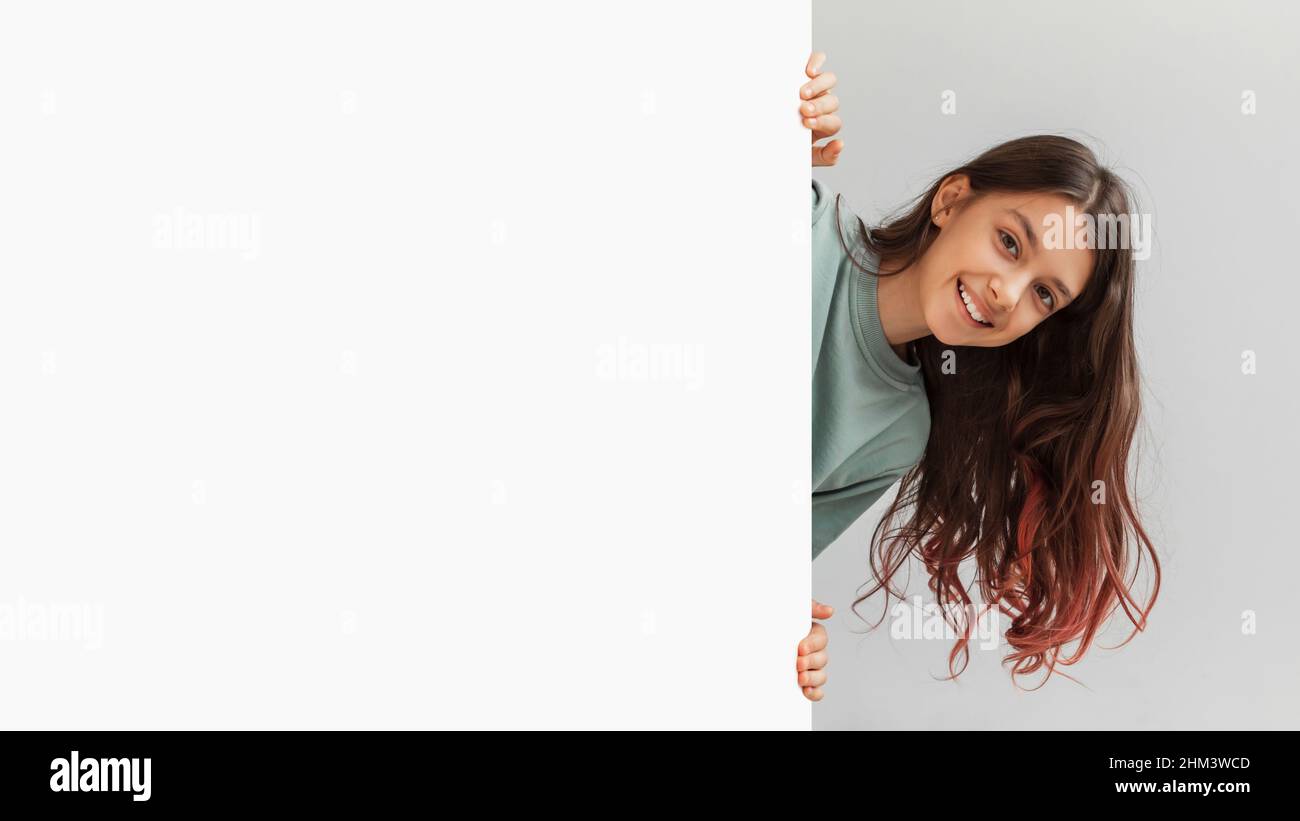Happy Girl Hiding Behind Empty White Board Over Gray Background Stock ...