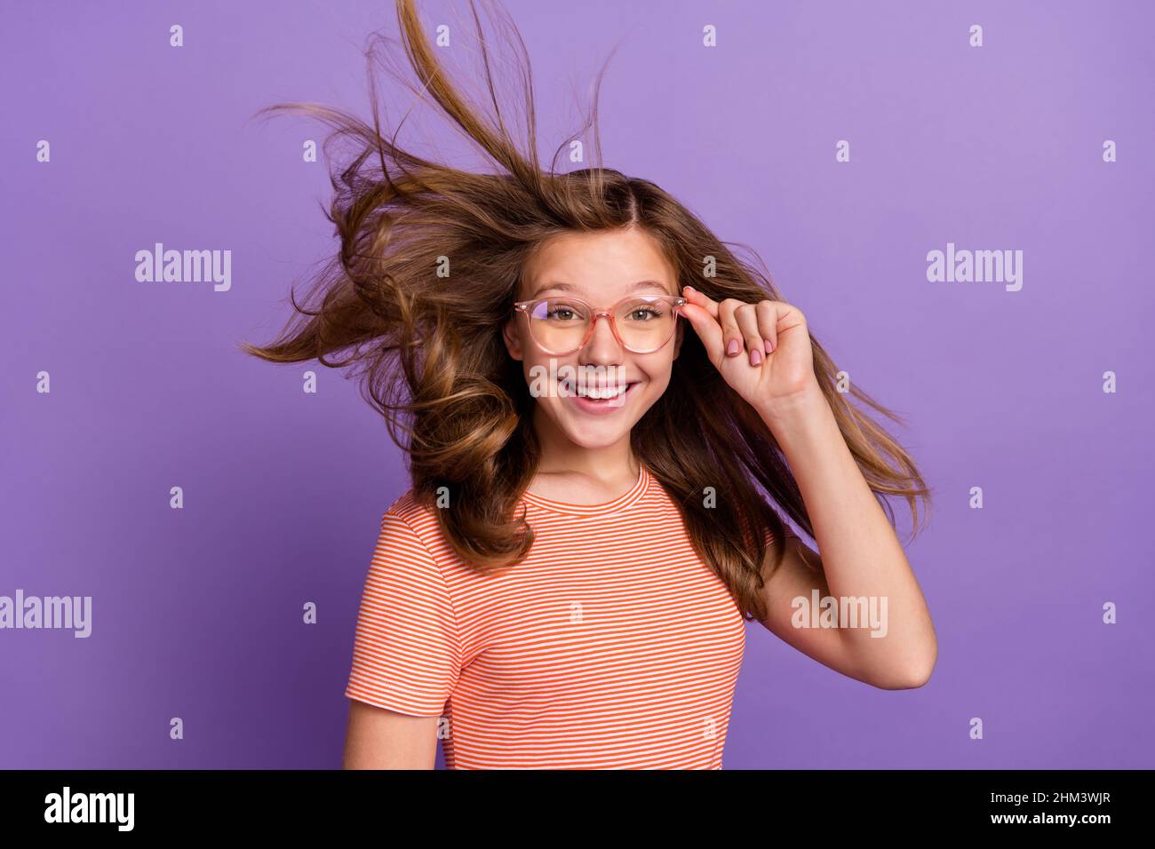 Portrait of attractive amazed cheerful girl nerd geek hair flying ...
