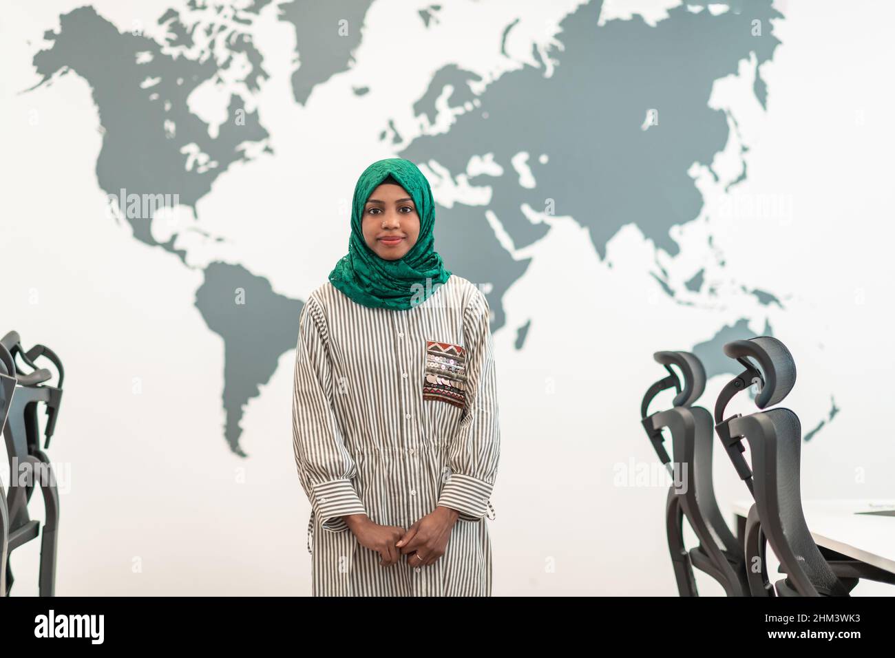 Portrait of muslim female software developer with green hijab standing ...