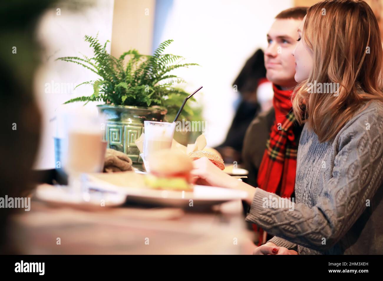 Happy couple eating fast food burger and doner in fast food cafe Stock ...