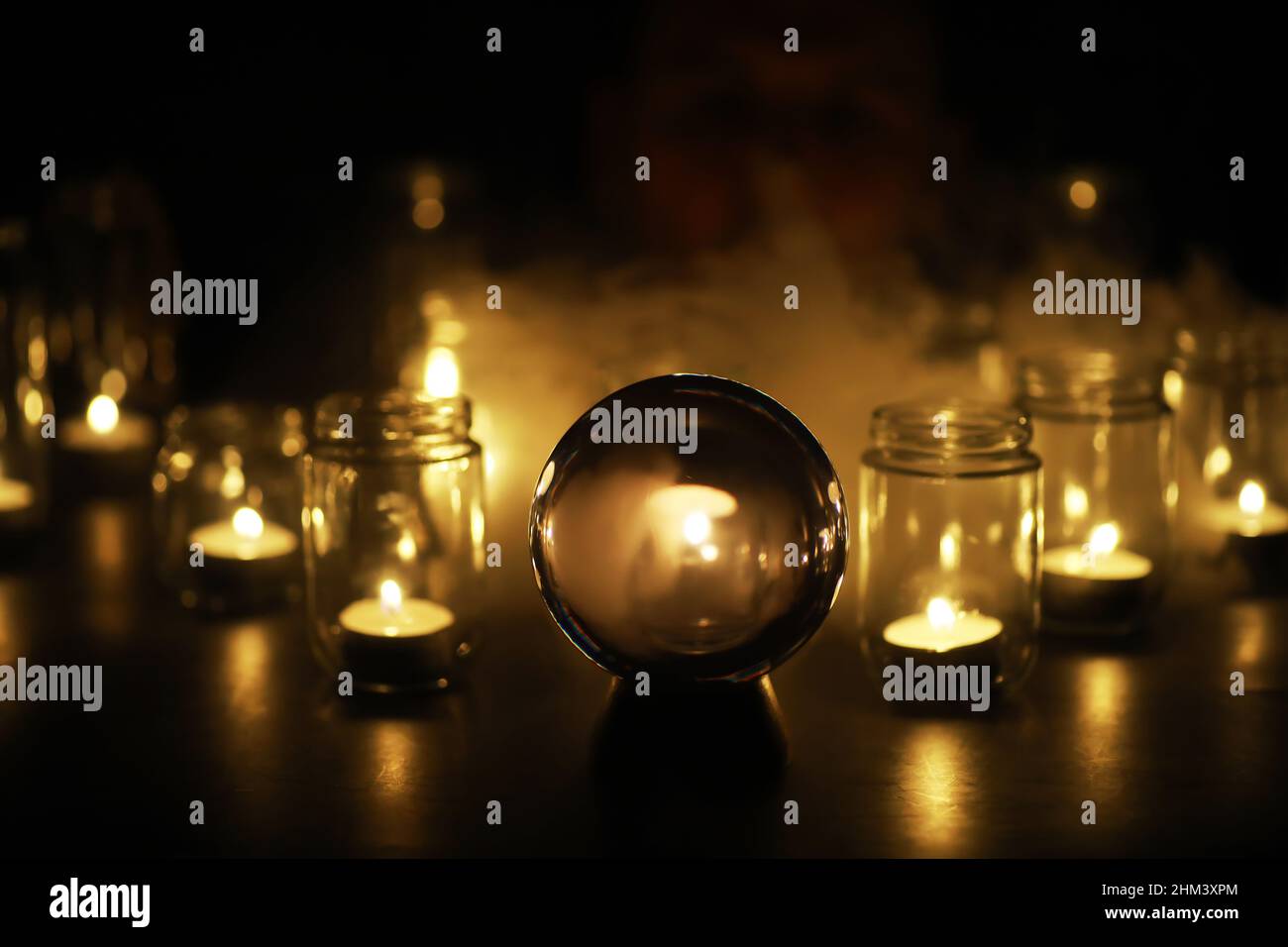 Black background with ball and candles. Divination and prediction of ...