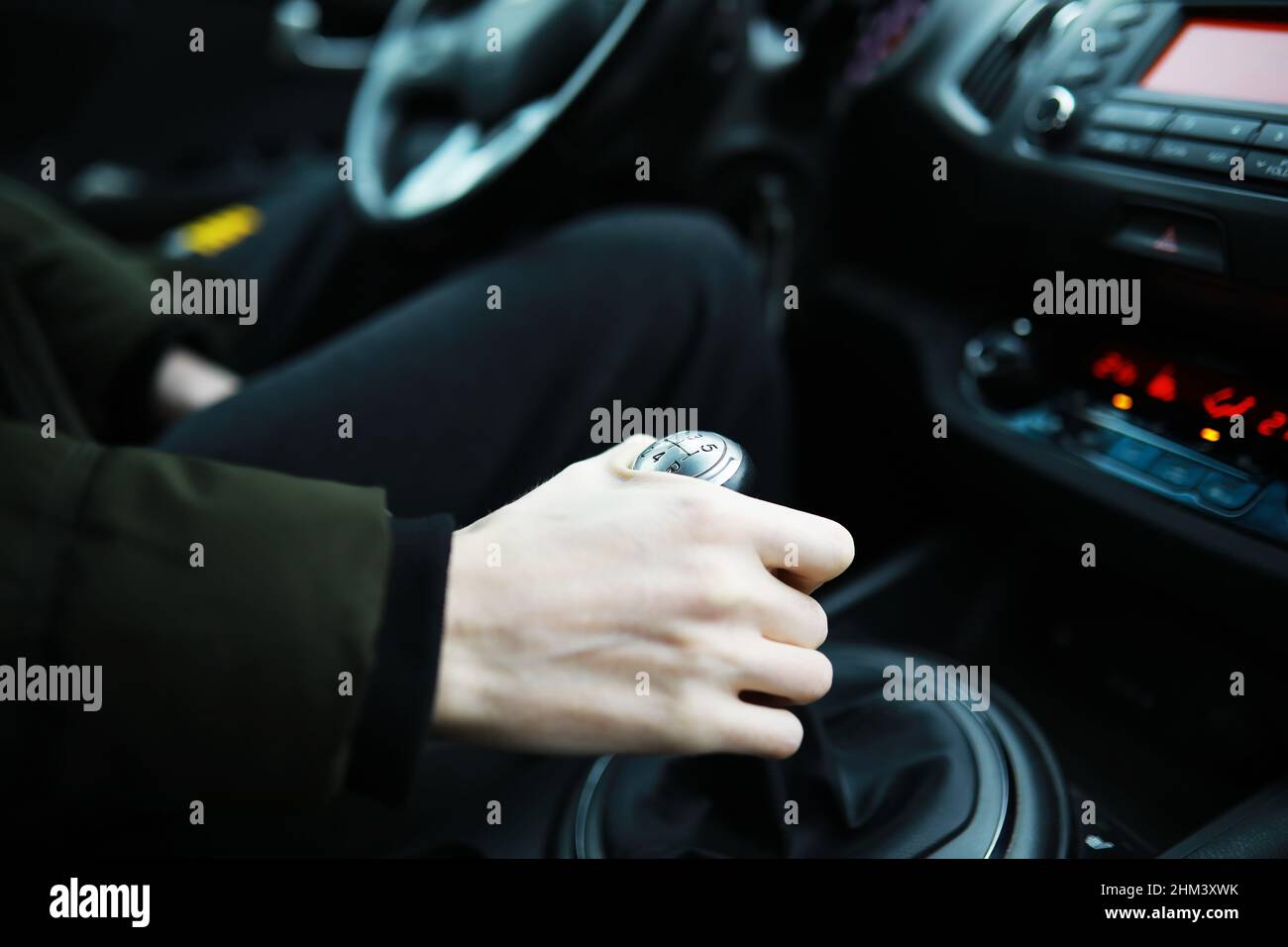 Hand on car gear knob. The driver switches the speed in the car. Hand ...