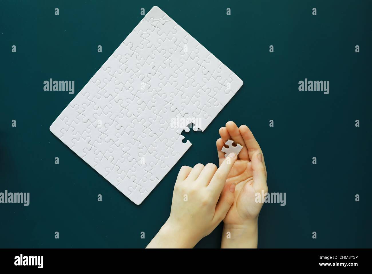 Intellectual puzzles. The puzzle empty. The hand puts together puzzle ...