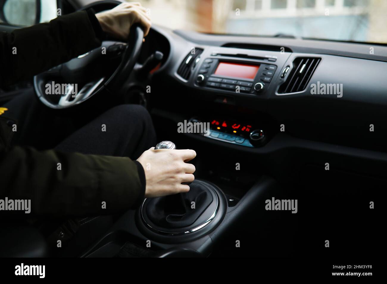 Hand on car gear knob. The driver switches the speed in the car. Hand ...