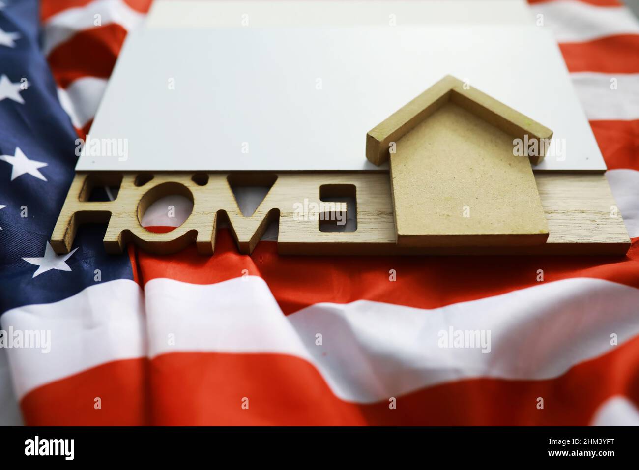 House symbol on American flag. Mortgage credit lending. Housing safety ...