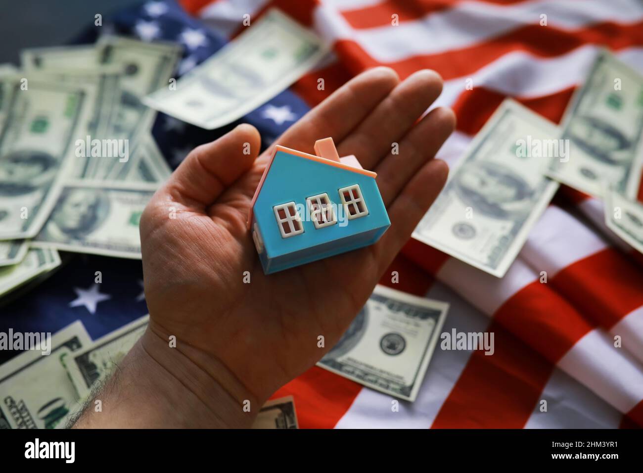 House symbol on American flag. Mortgage credit lending. Housing safety ...