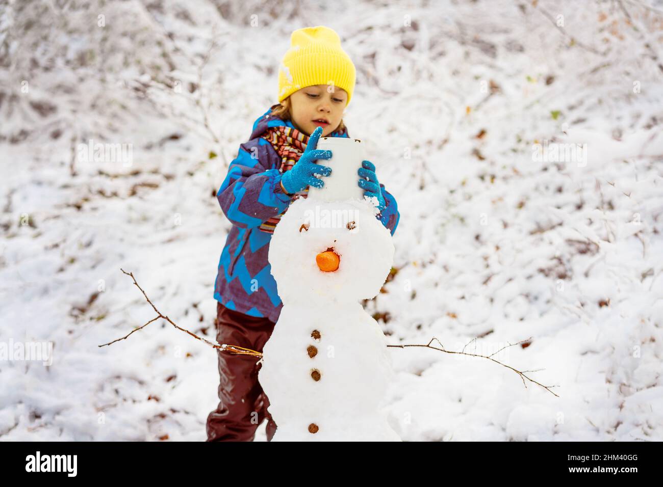 Snowman making hi-res stock photography and images - Alamy