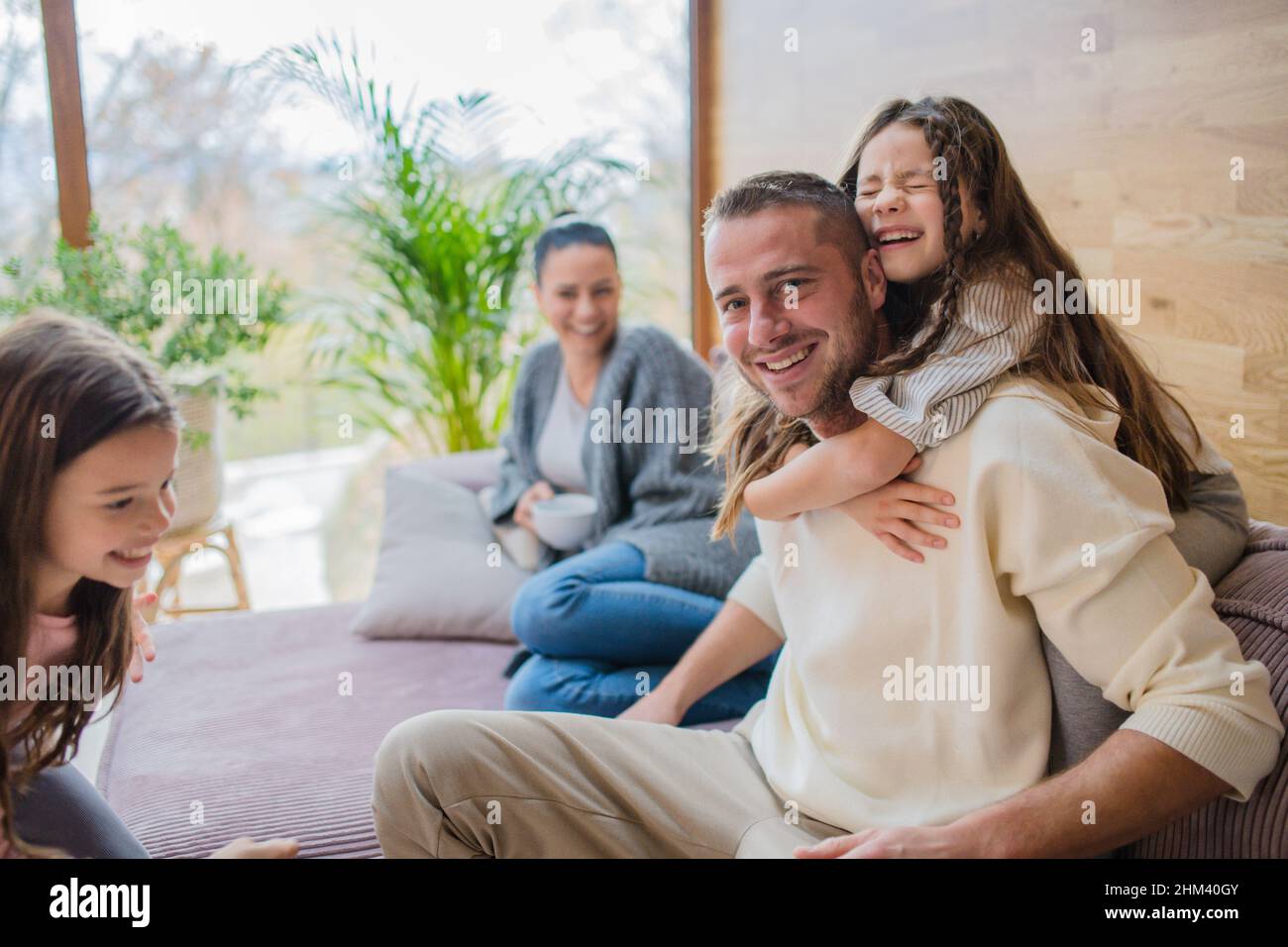 Two happy sisters having fun with father at home Stock Photo - Alamy