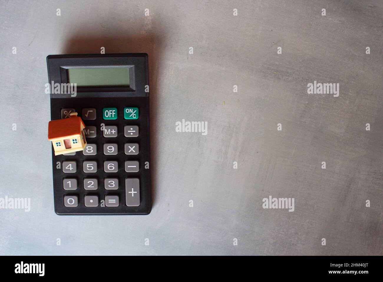 Toy house and calculator. Property cost calculation concept. Copy space ...