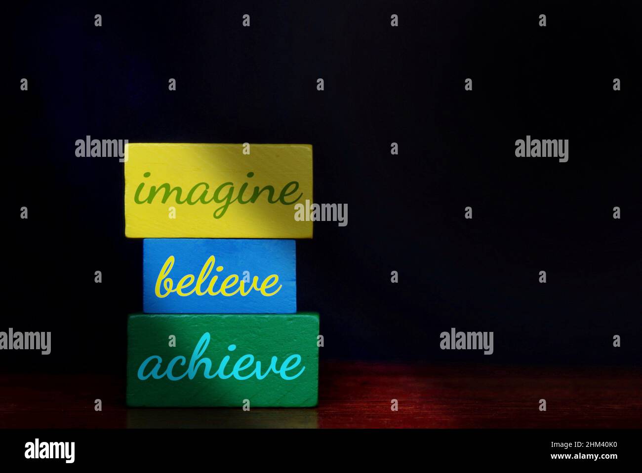 Motivational quotes. Wooden cubes with text imagine, believe and ...