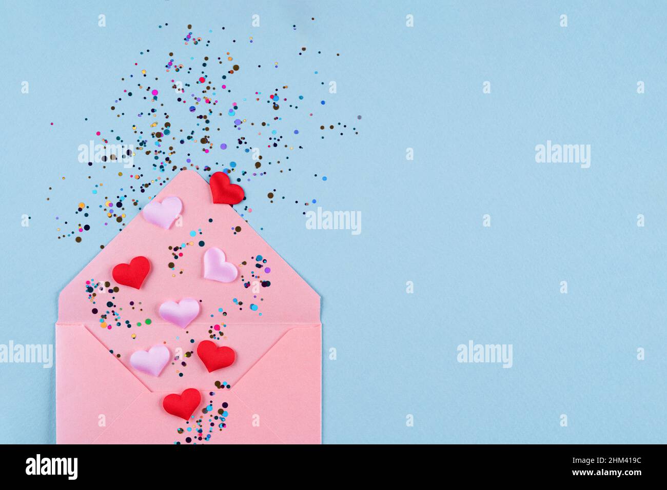 Valentine's day festive background. Pink envelope with red hearts and ...