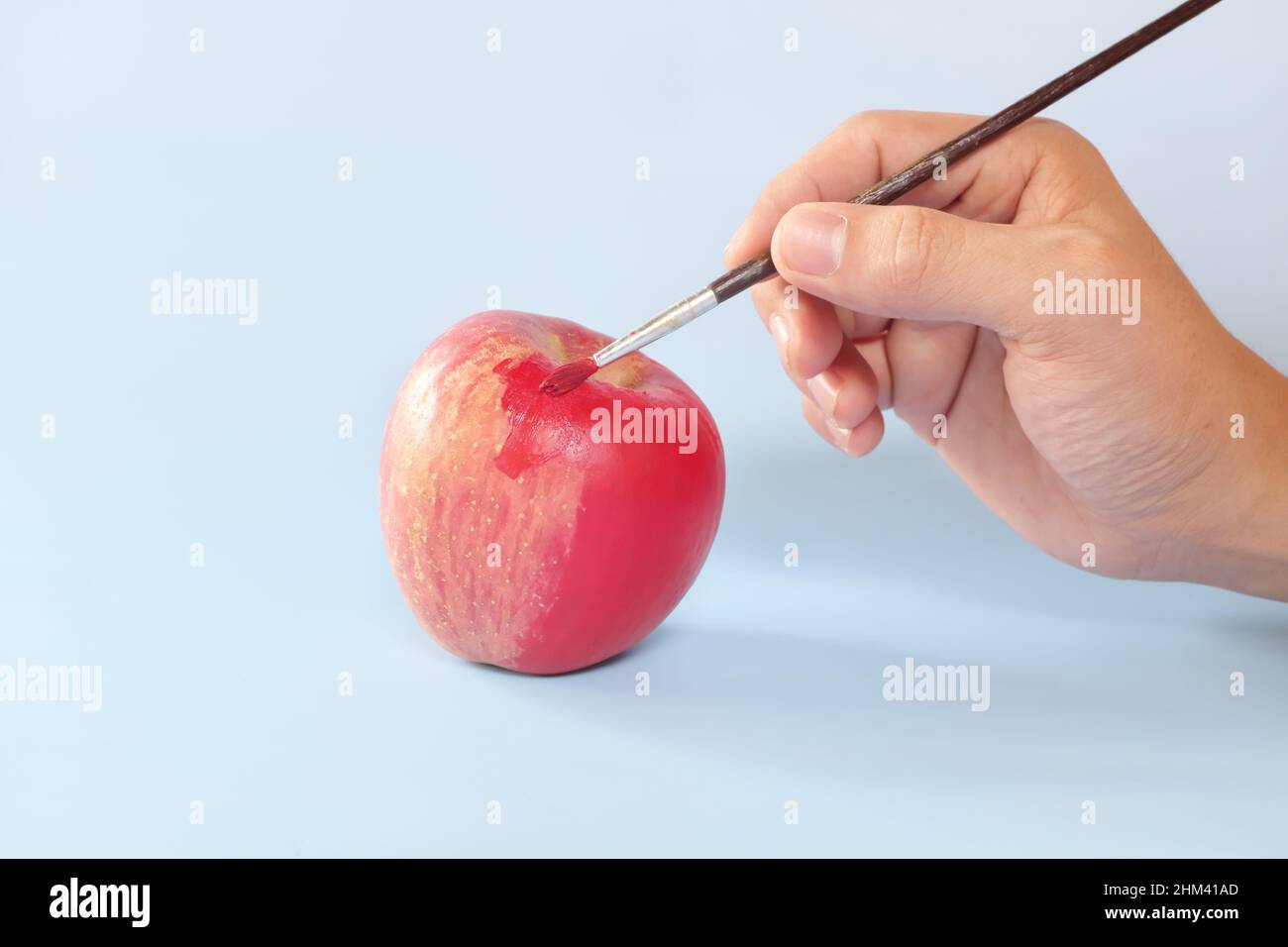 Fake food, coloring, fraud and fraudulent food concept. Apple painted ...