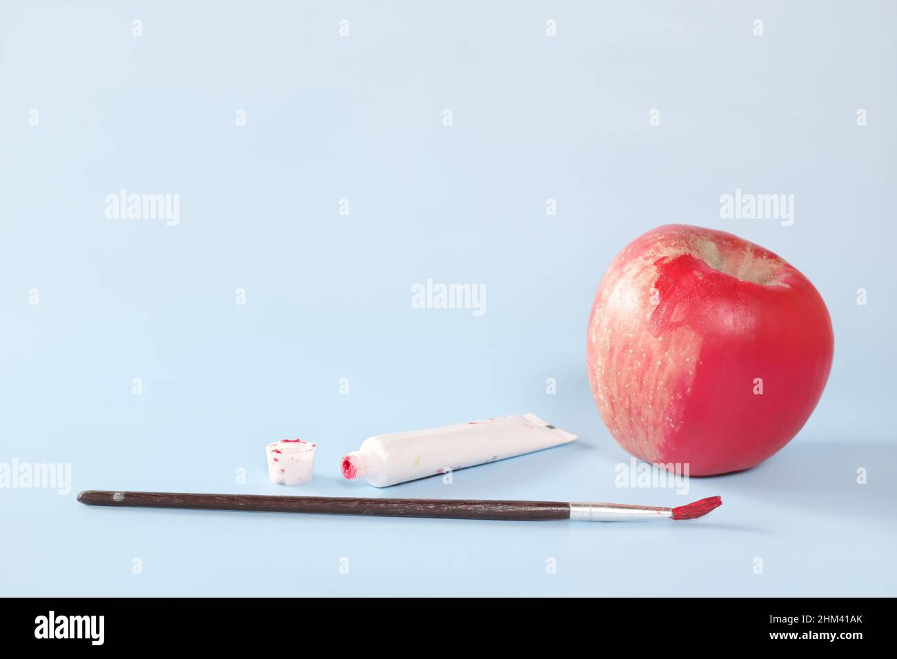 Fake food, coloring, fraud and fraudulent food concept. Apple painted ...