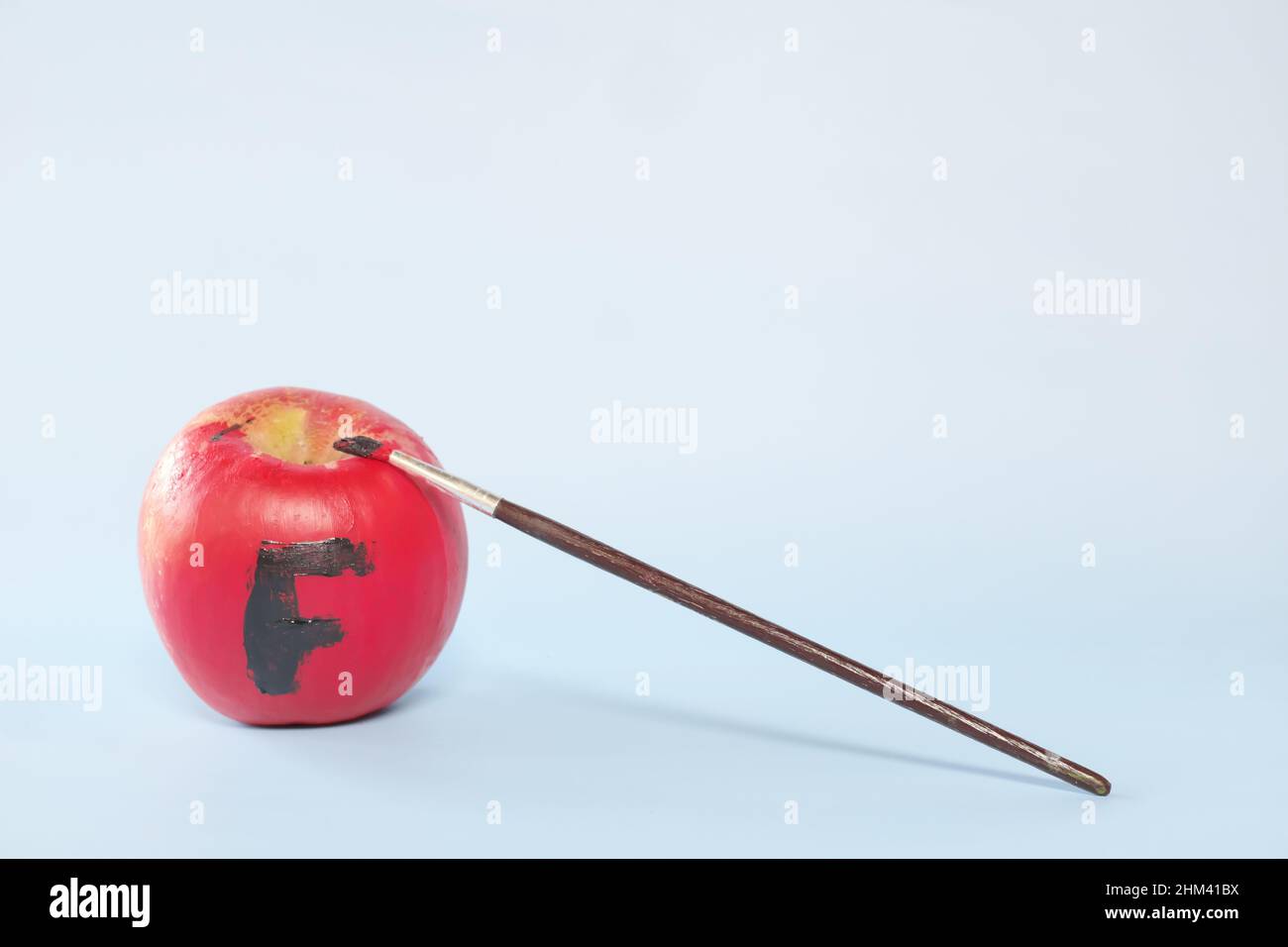 Fake food, coloring, fraud and fraudulent food concept. Apple painted ...